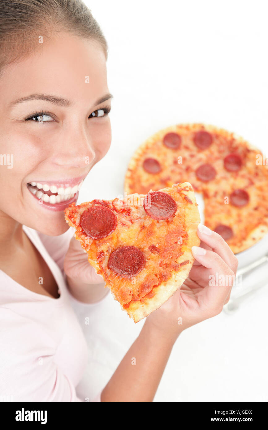 Pizza. Woman eating pizza happy smiling looking at camera Stock Photo ...
