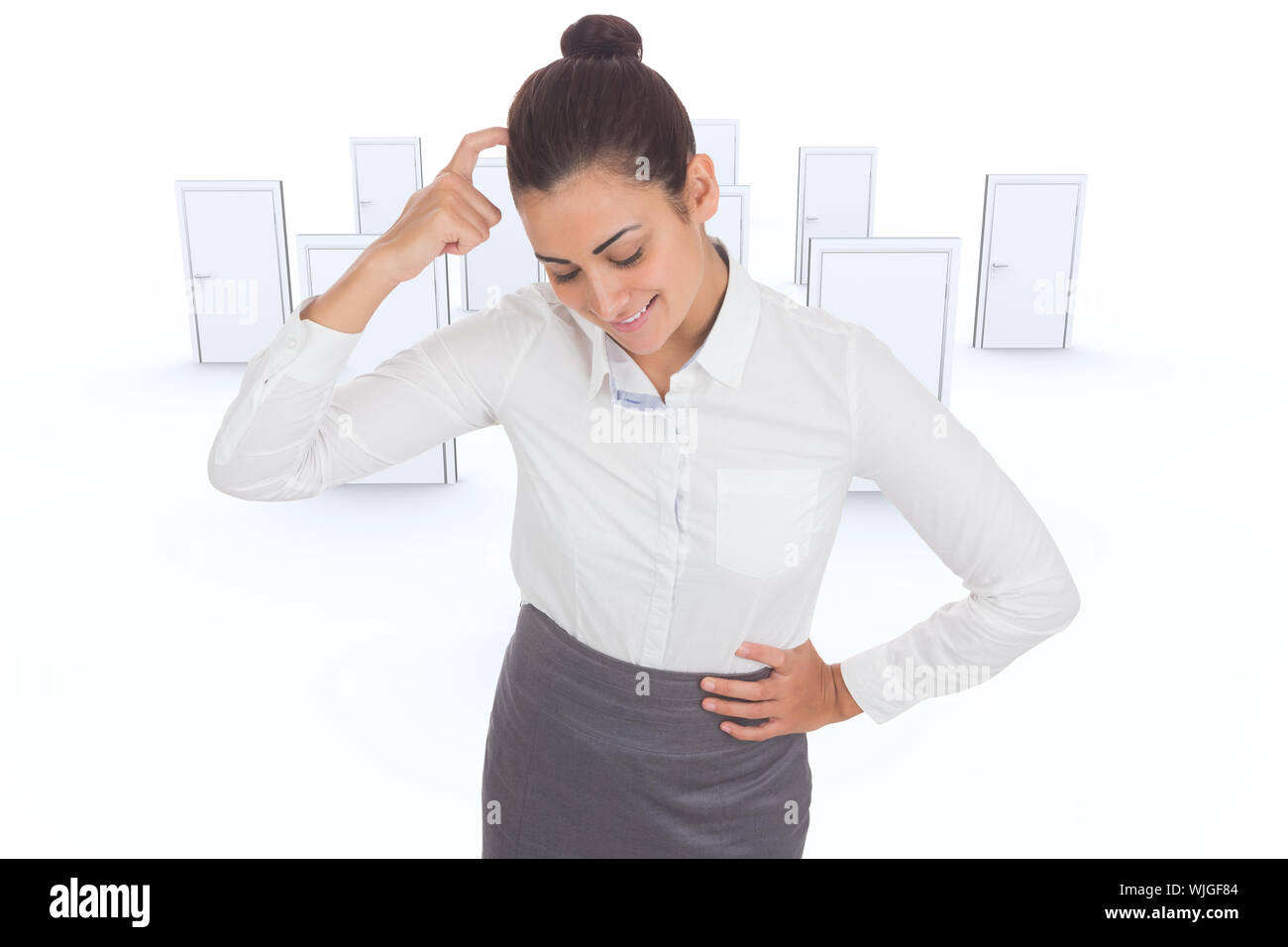 Smiling thoughtful businesswoman against many doors closed shut Stock ...