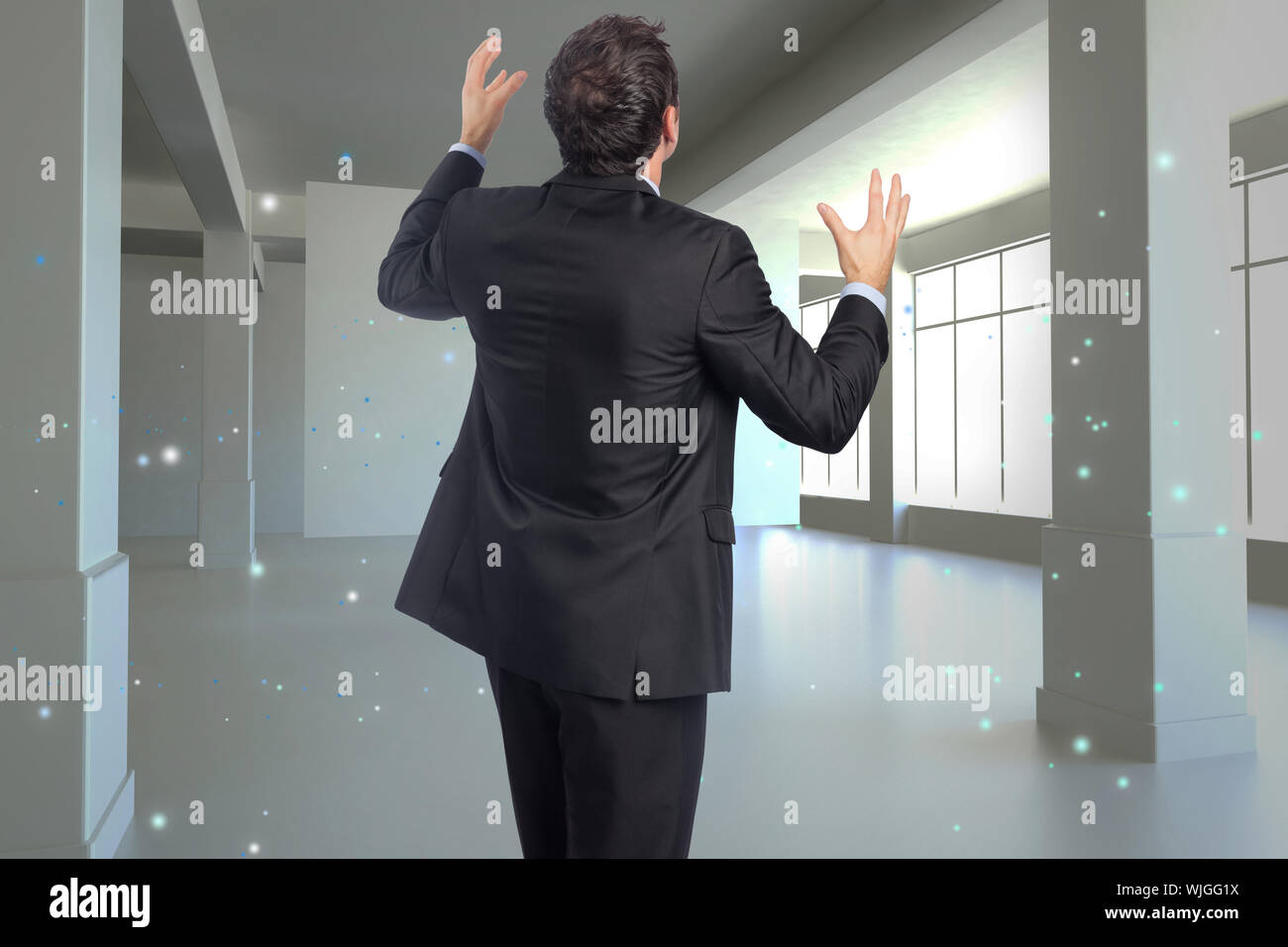 Stressed businessman gesturing against screen in room with sparks Stock ...