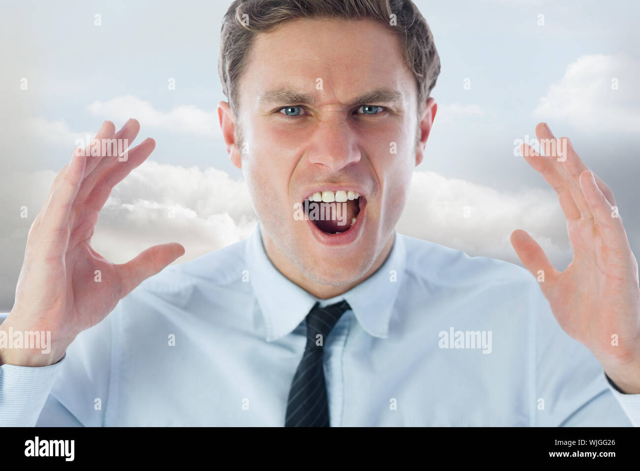 Angry businessman shouting against clouds in a room Stock Photo - Alamy
