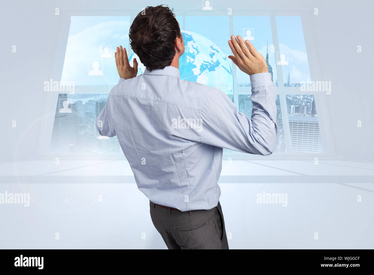 Businessman standing with arms pushing up against server tower seen ...