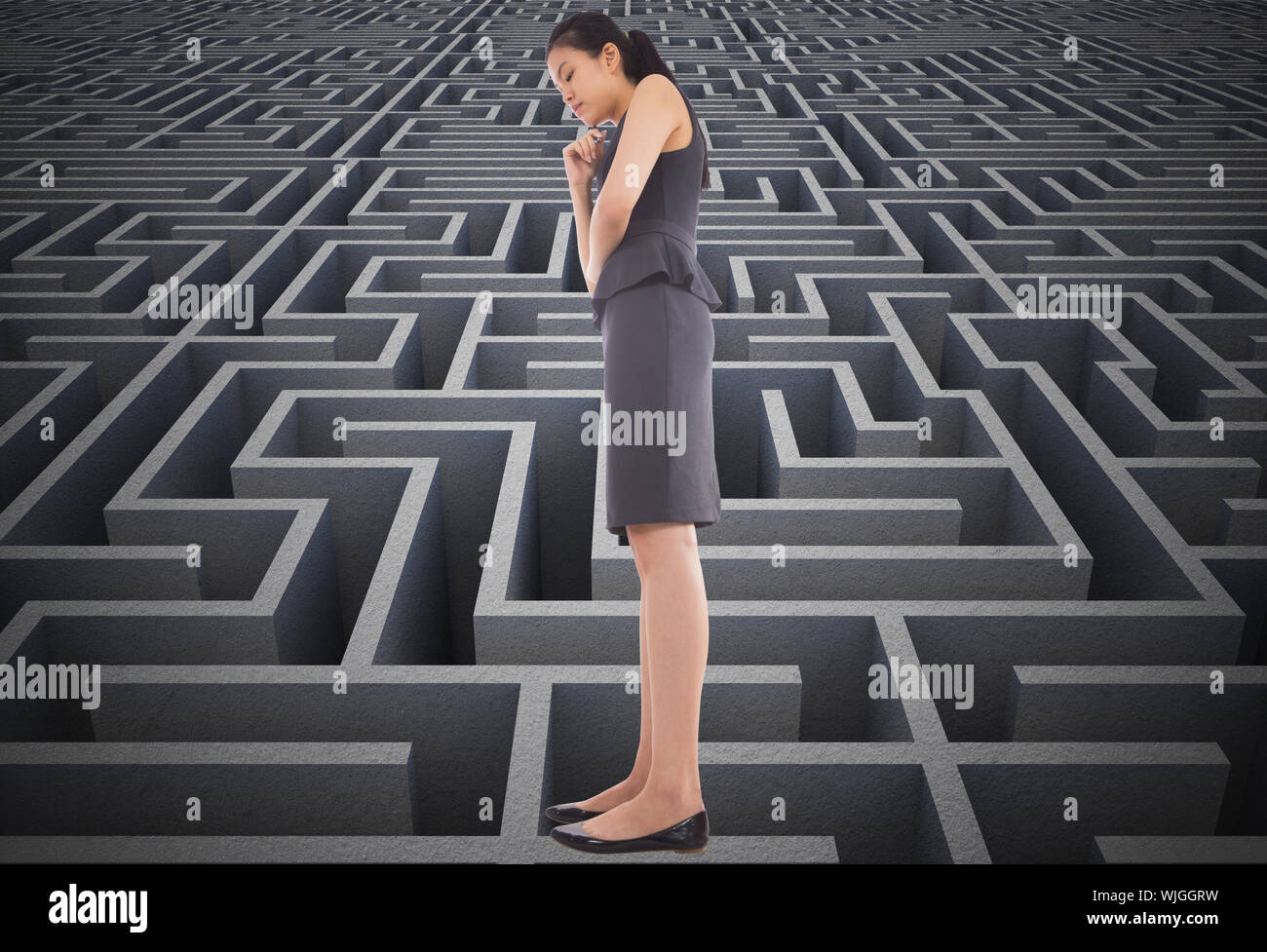 Thinking businesswoman against maze puzzle Stock Photo - Alamy