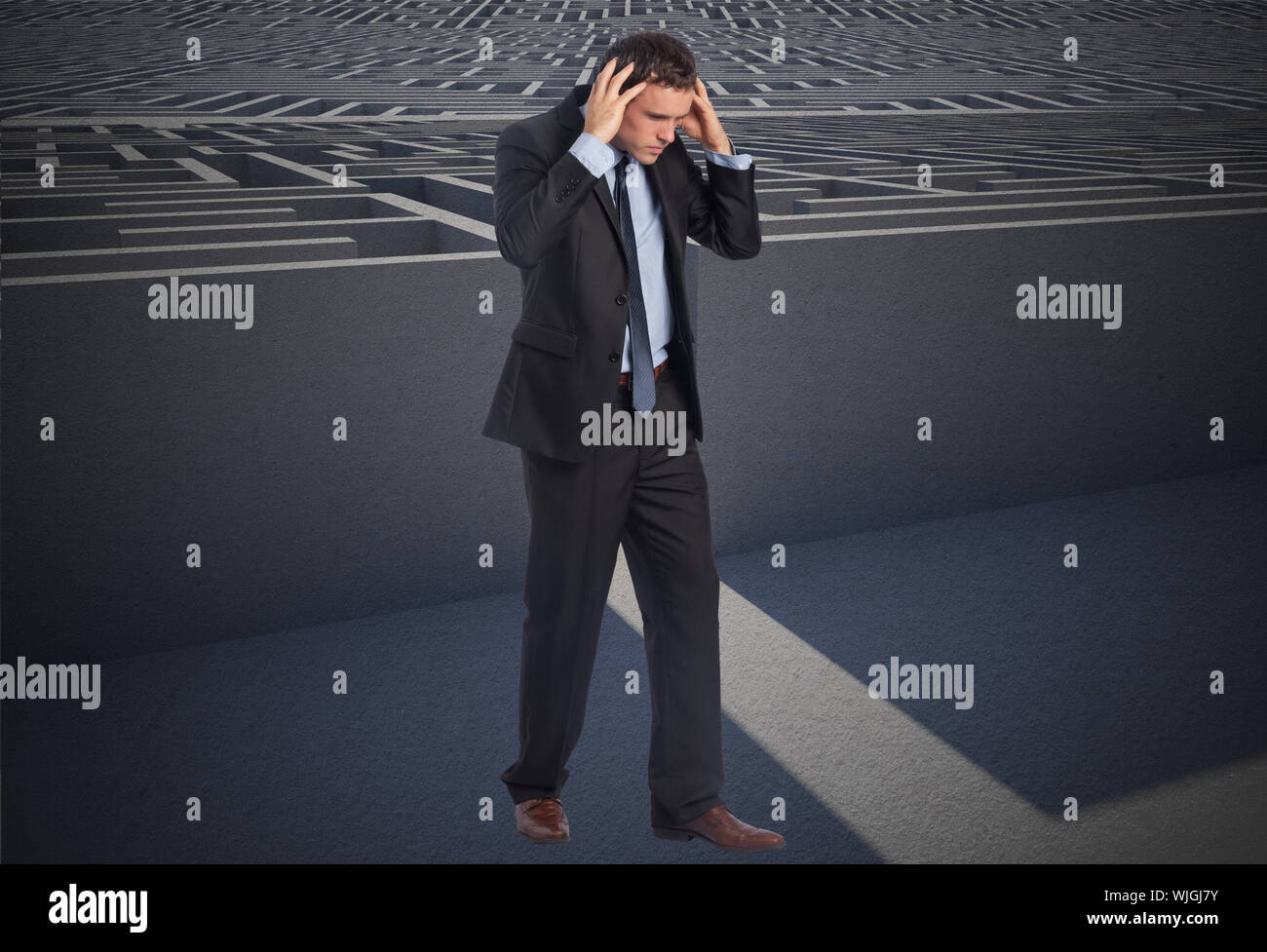 Stressed businessman with hands on head against entrance to difficult ...