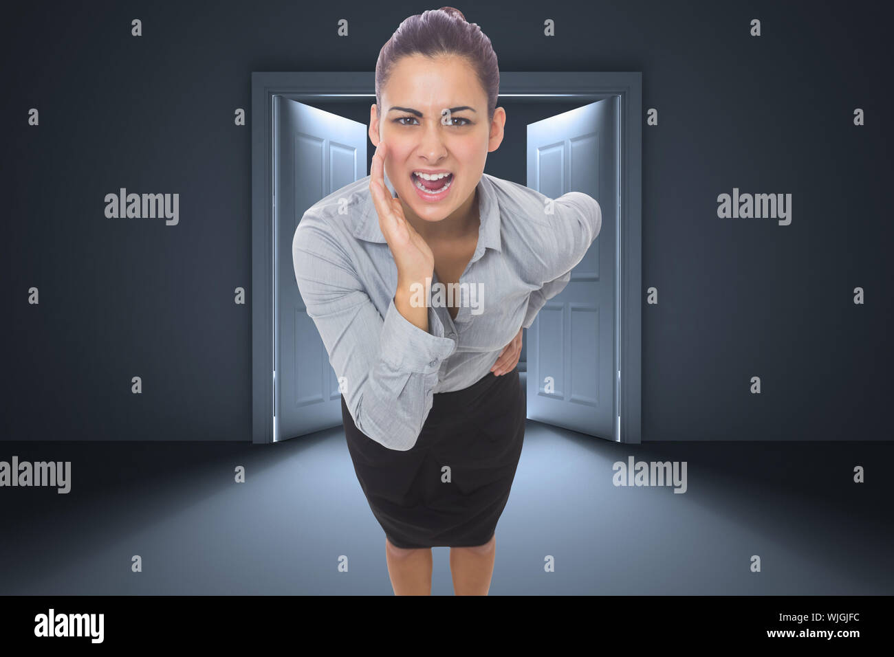 Businesswoman shouting against door opening in dark room Stock Photo ...