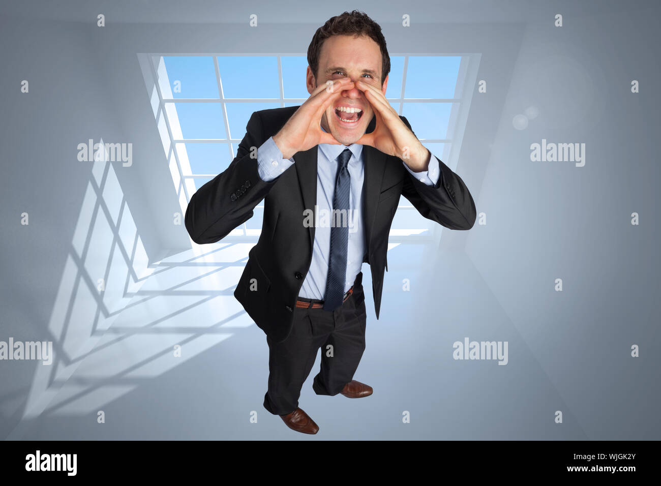 Shouting businessman against room with large window showing city Stock ...