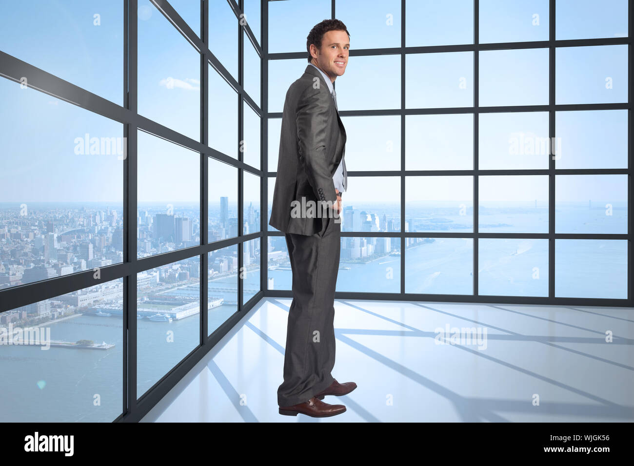 Businessman with hand on hip against screen showing international ...