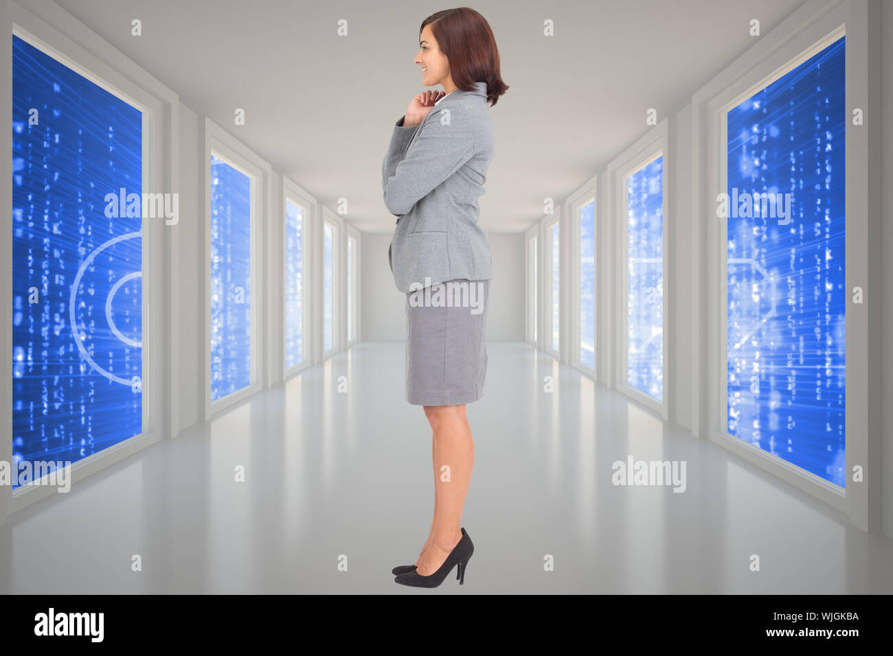 Happy businesswoman against glowing key seen through windows Stock ...
