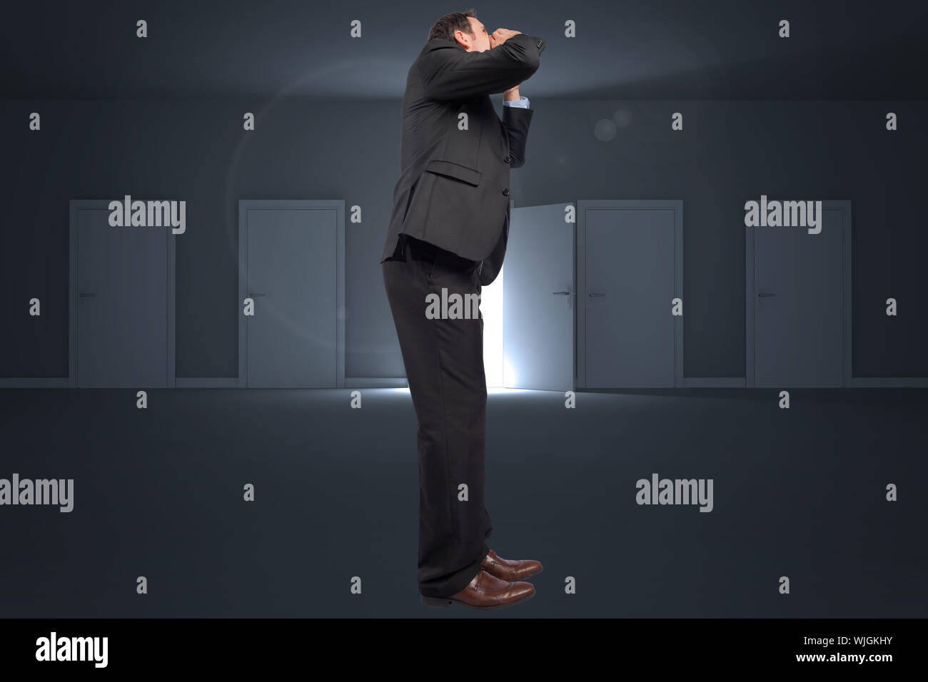 Shouting businessman against door opening to show red arrow Stock Photo ...