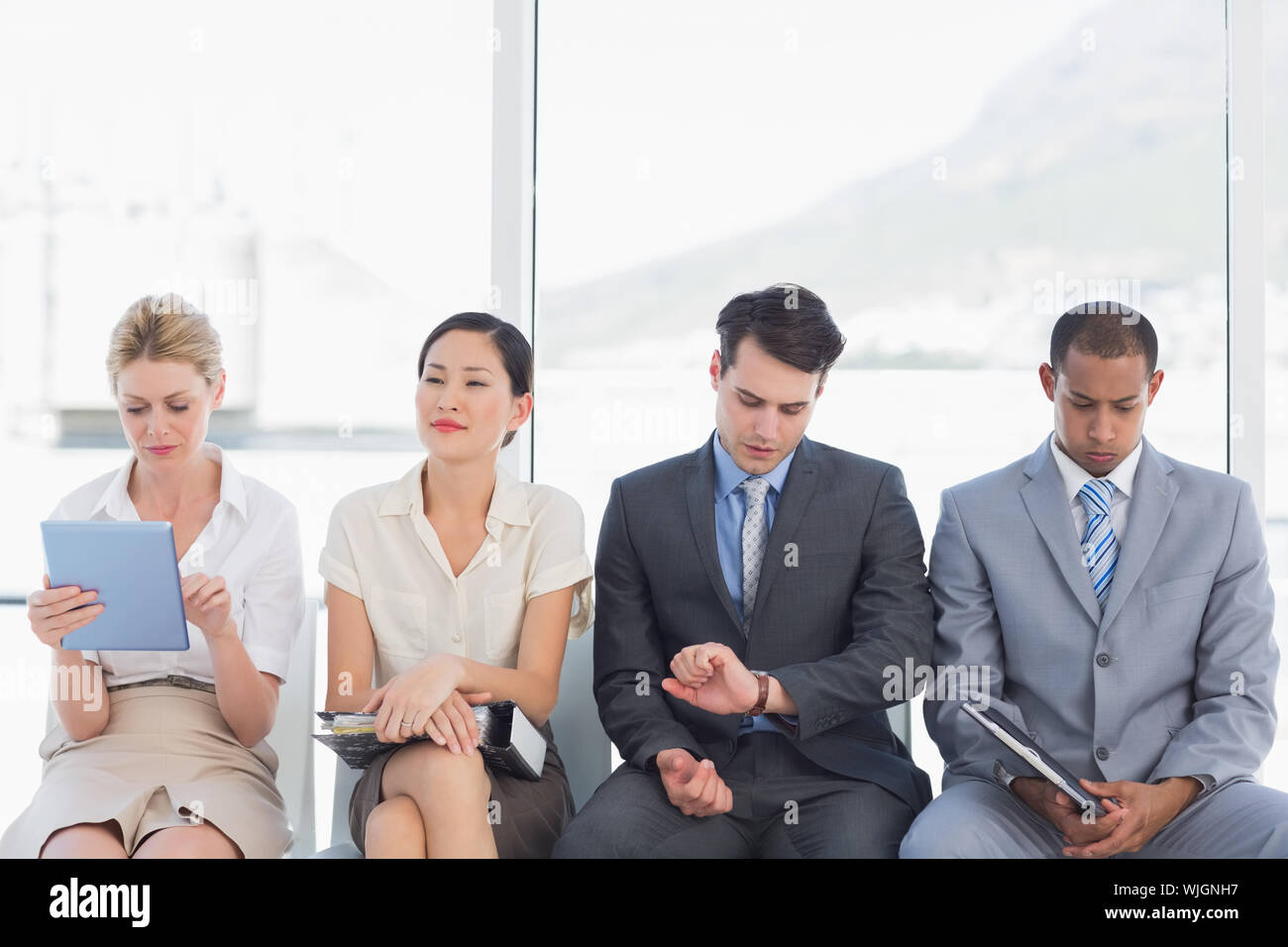 Four business people waiting for job interview in a bright office Stock ...