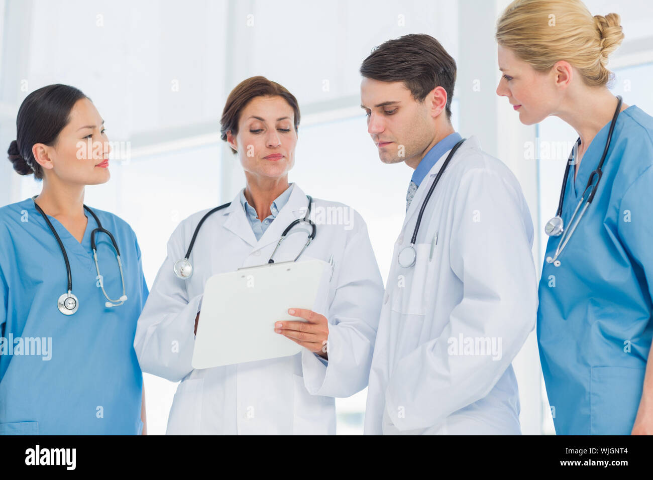 Group of doctors looking at report in the hospital Stock Photo - Alamy
