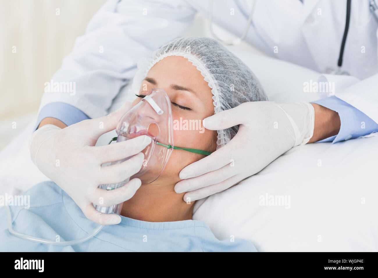 Young female patient receiving artificial ventilation in the hospital ...