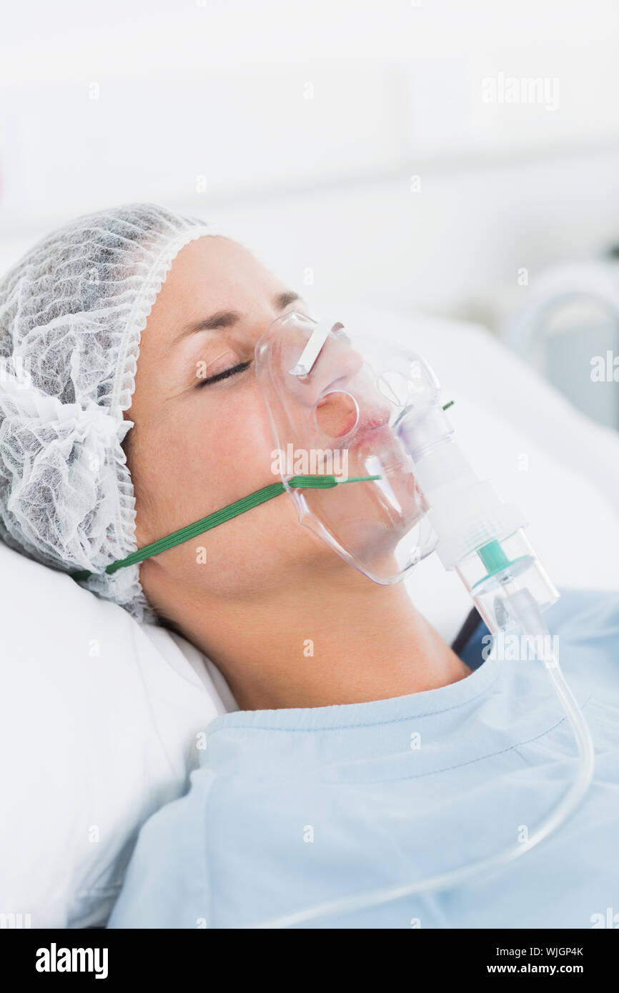Young female patient receiving artificial ventilation in the hospital ...