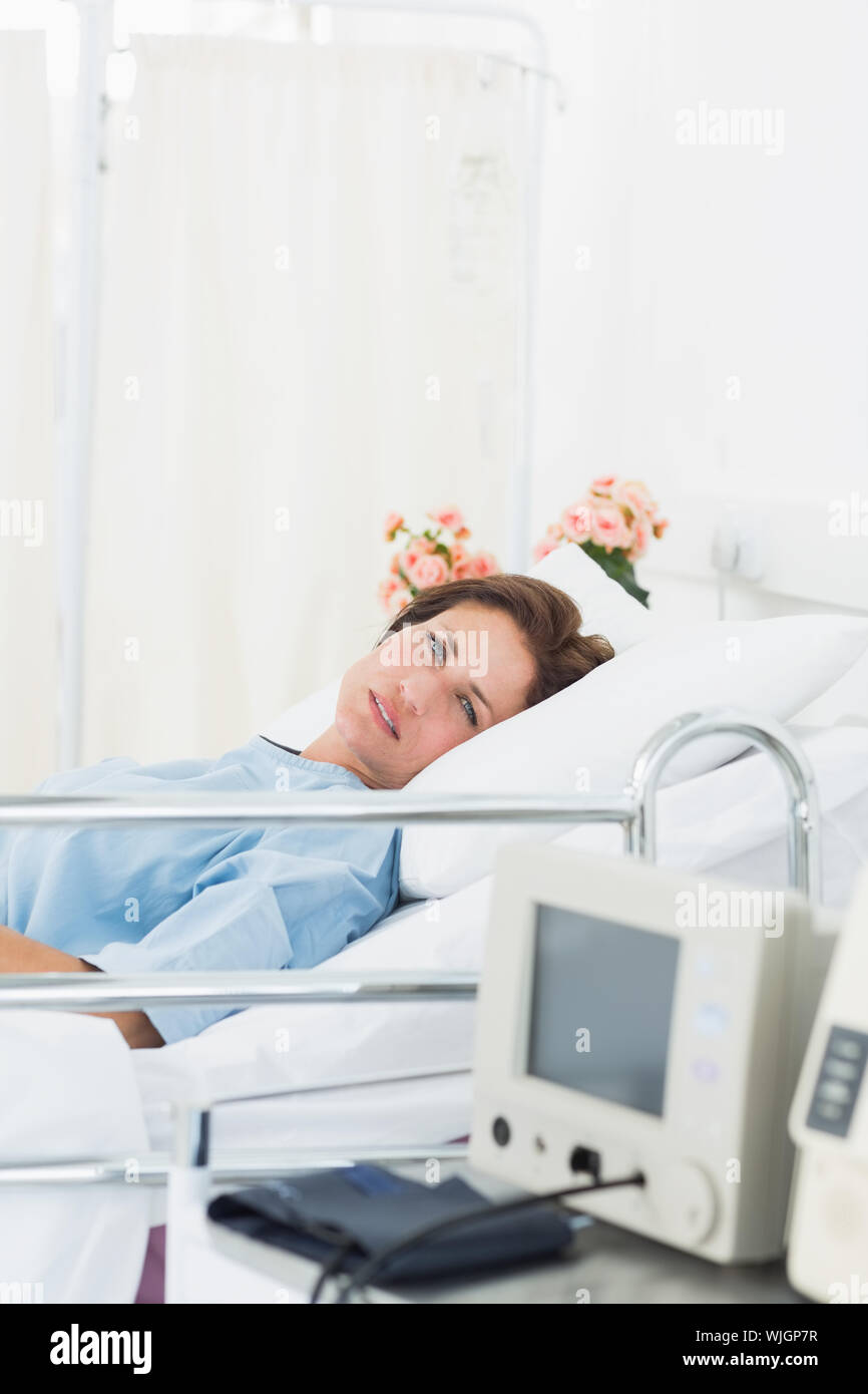 Female patient lying in medical bed at the hospital ward Stock Photo ...