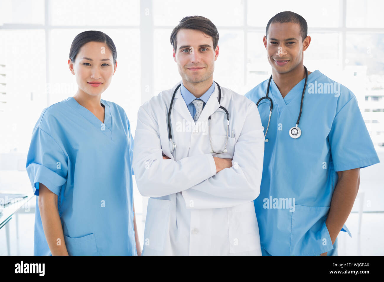 Group portrait of three doctors standing together at the hospital Stock Photo - Alamy