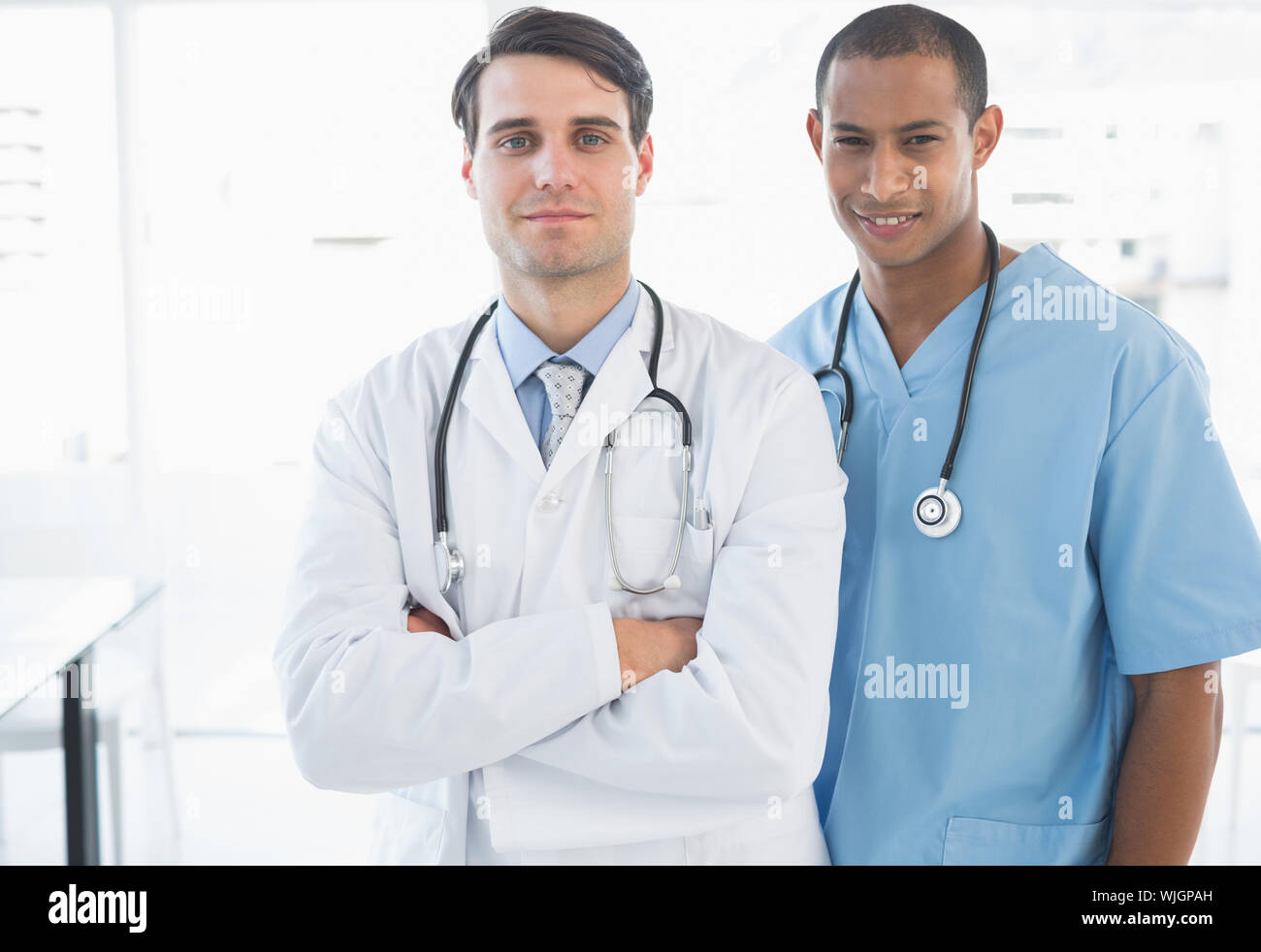 Portrait of two confident doctors standing together in the hospital ...