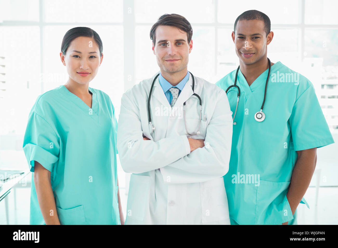 Group portrait of three doctors standing together at the hospital Stock ...