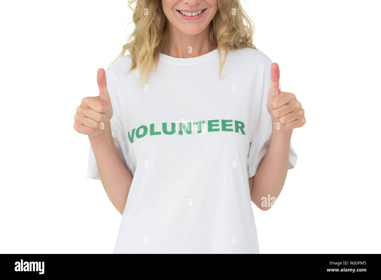 Mid section of a happy female volunteer gesturing thumbs up over white ...