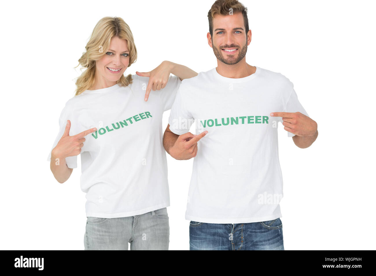 Portrait of two happy volunteers pointing to themselves over white ...