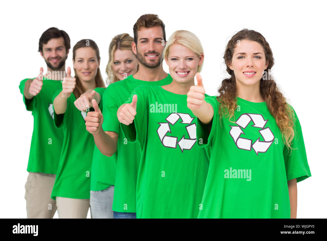 Group portrait of young people in recycling symbol t-shirts gesturing ...
