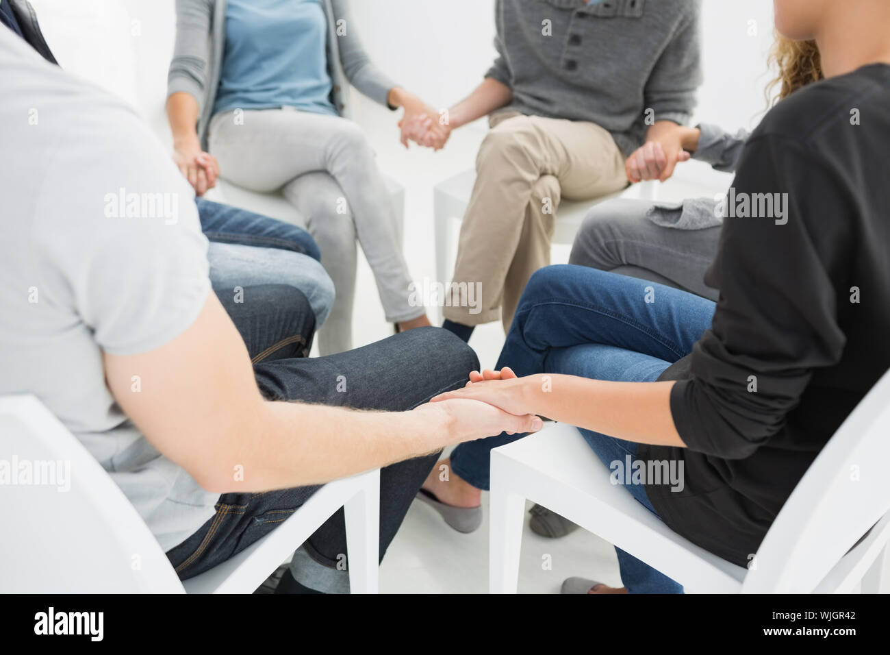 Group therapy in session sitting in a circle with therapist Stock Photo ...