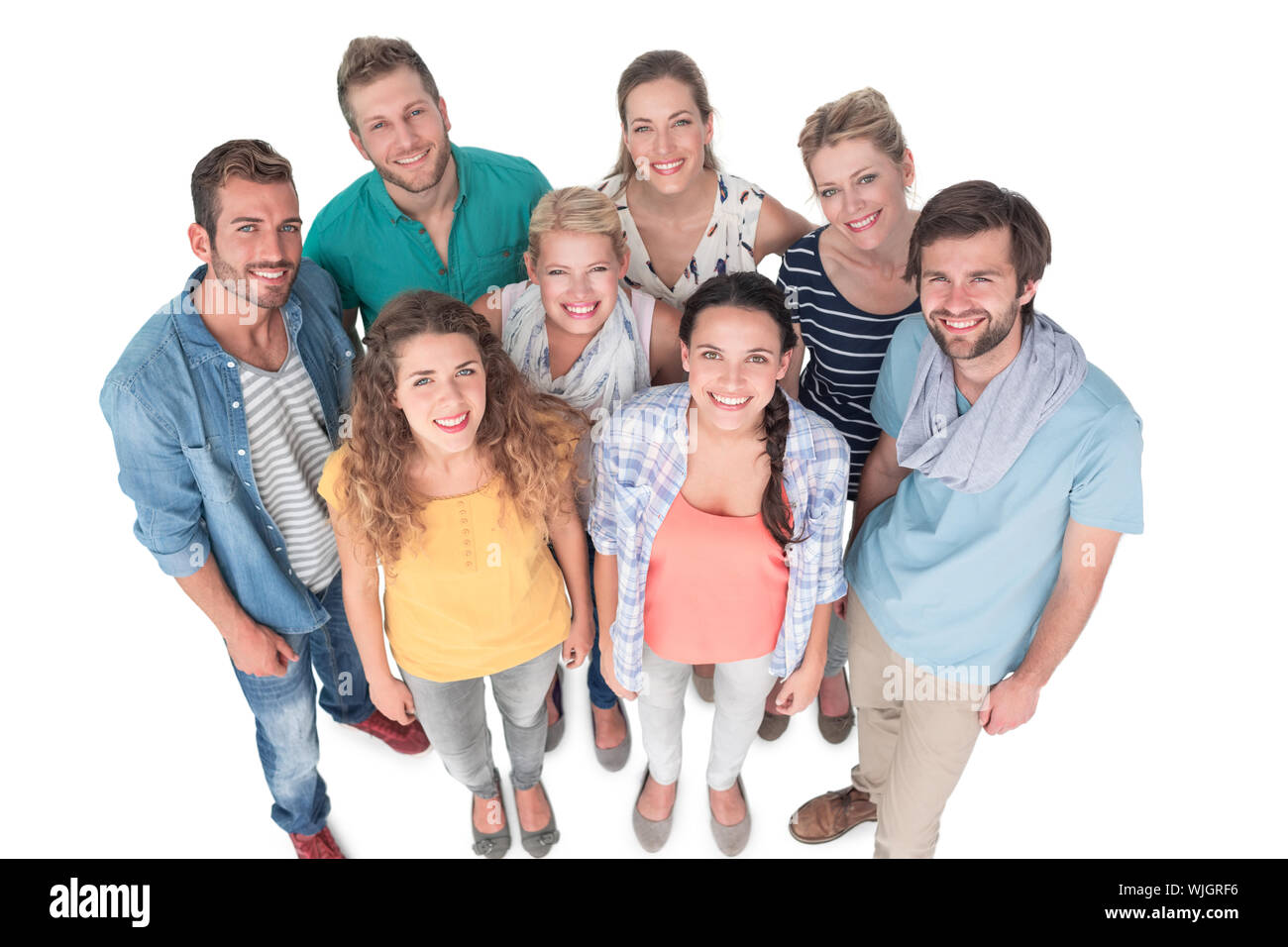Group portrait of casual happy people standing over white background ...