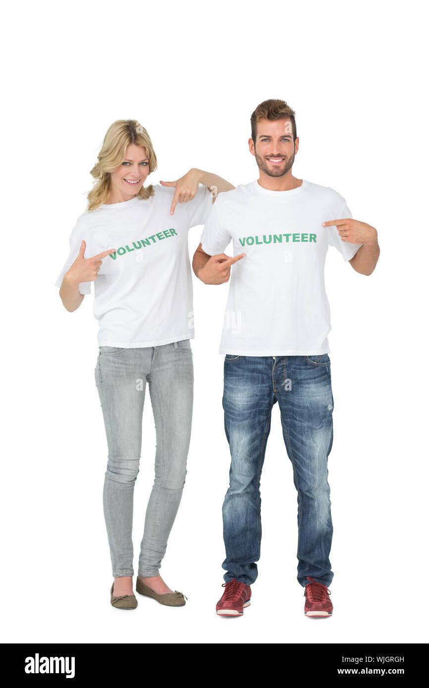 Portrait of two happy volunteers pointing to themselves over white ...