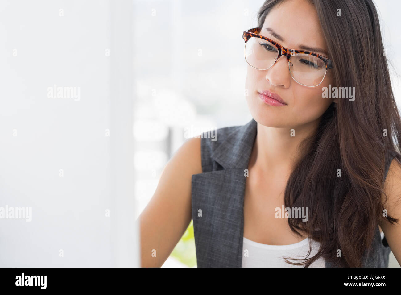 Young concentrated woman long brown hi-res stock photography and images ...