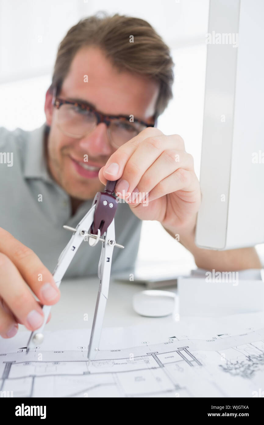 Close-up of a concentrated young man using compass on design Stock ...