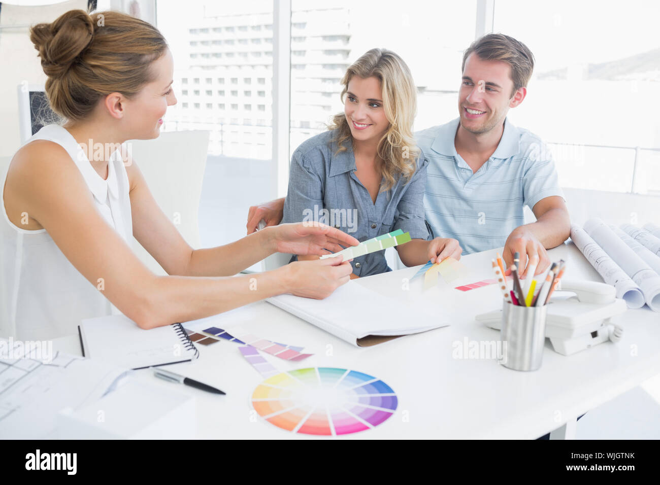Group of artists working on designs in a bright office Stock Photo - Alamy