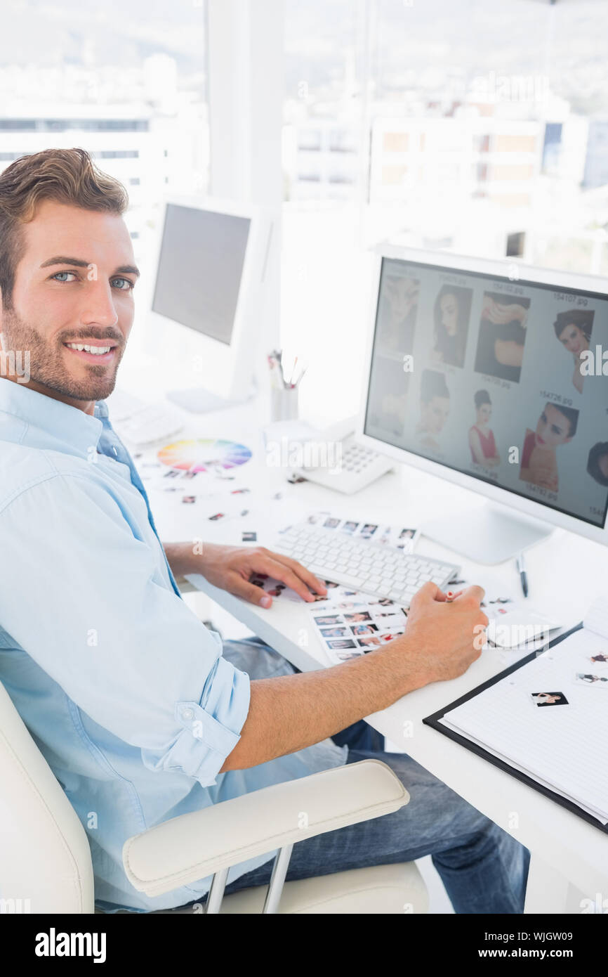 Side view portrait of a male photo editor working on computer in a ...