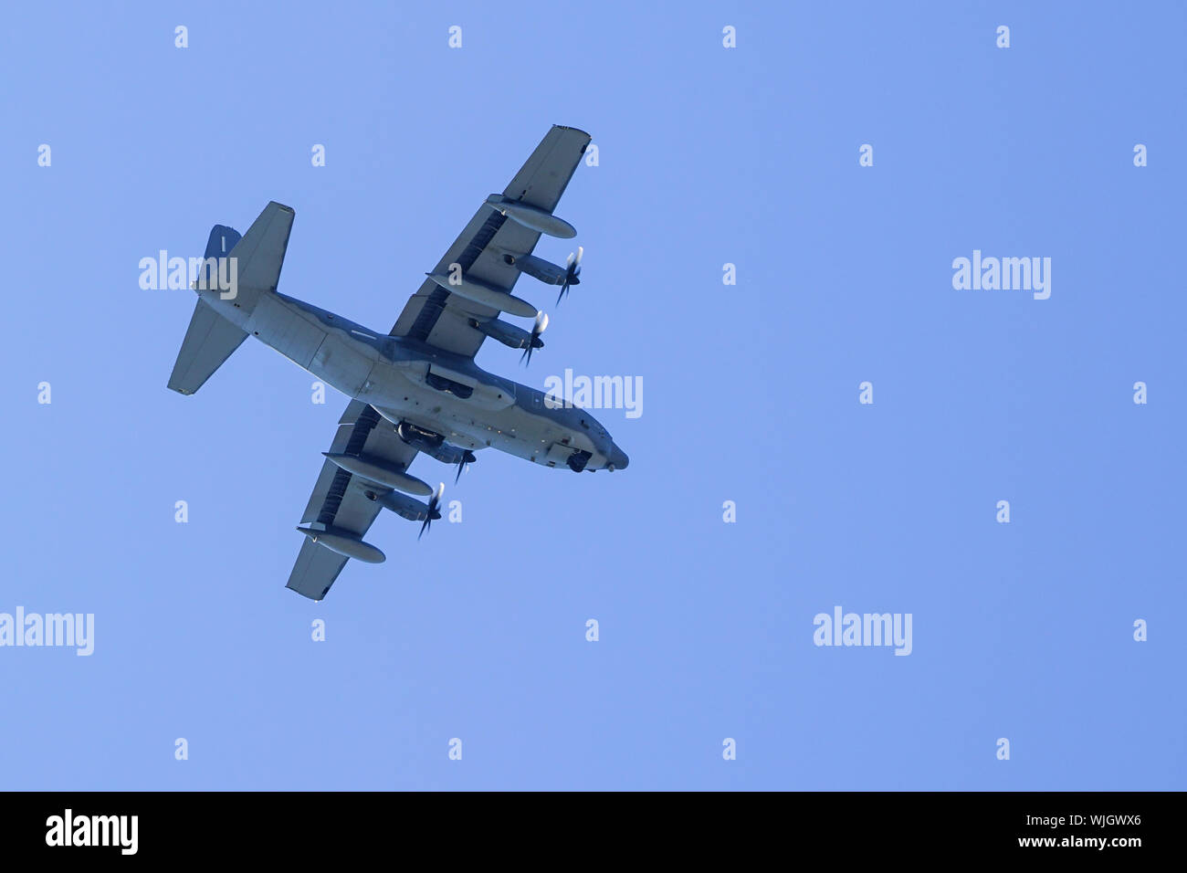 grey military transport plane fly on blue sky background Stock Photo ...