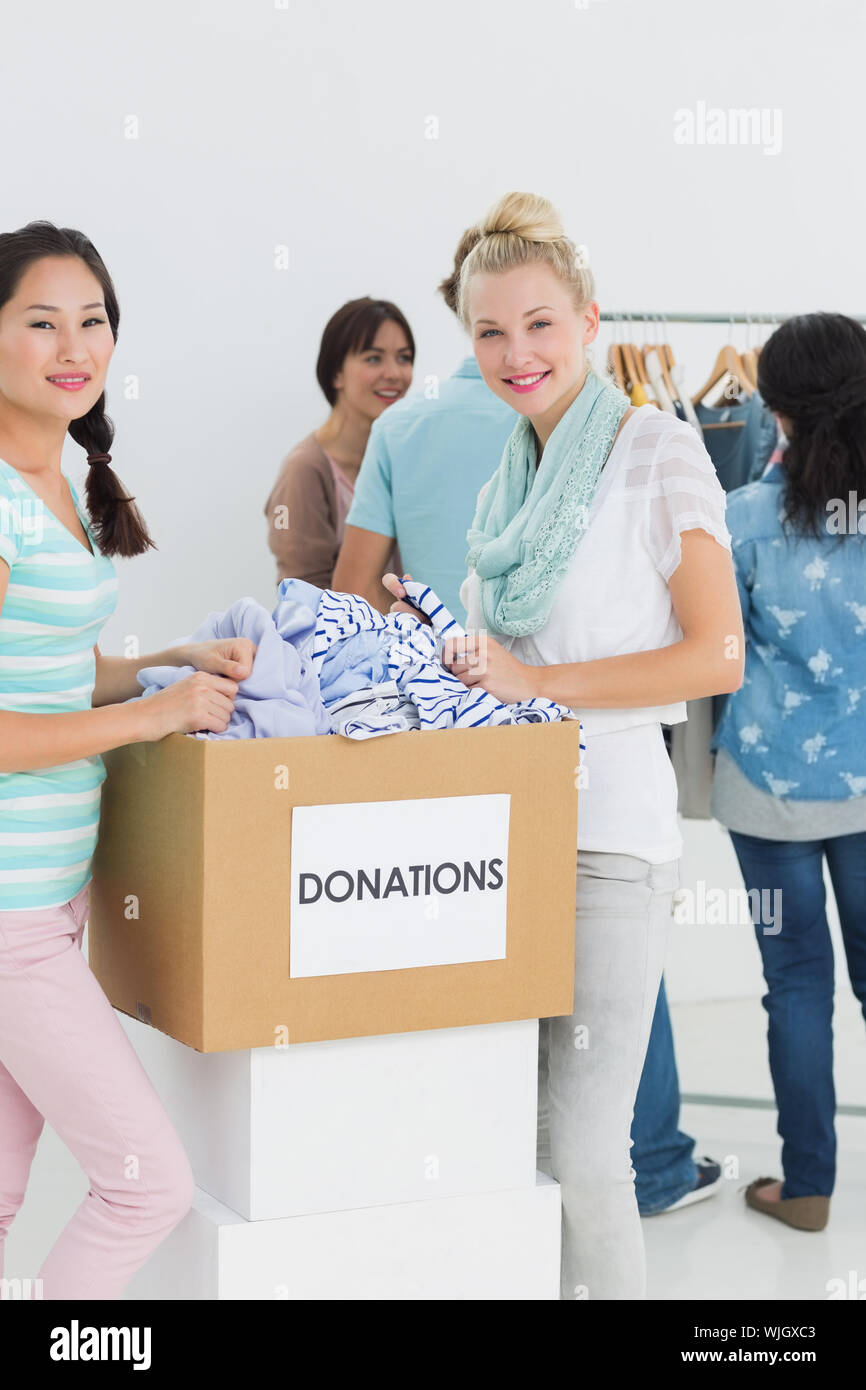 Group of young people with clothes donation Stock Photo - Alamy