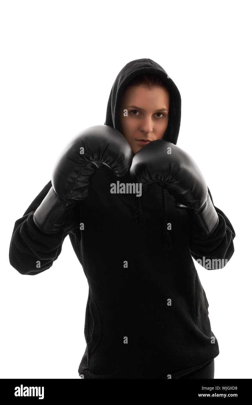 A portrait of a beautiful young girl with boxing gloves holding her ...