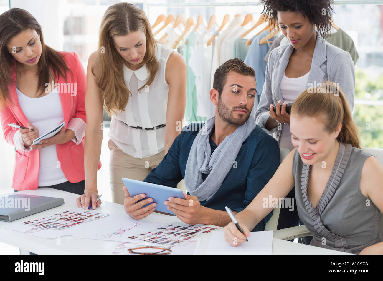 Group of fashion designers discussing designs in a studio Stock Photo ...