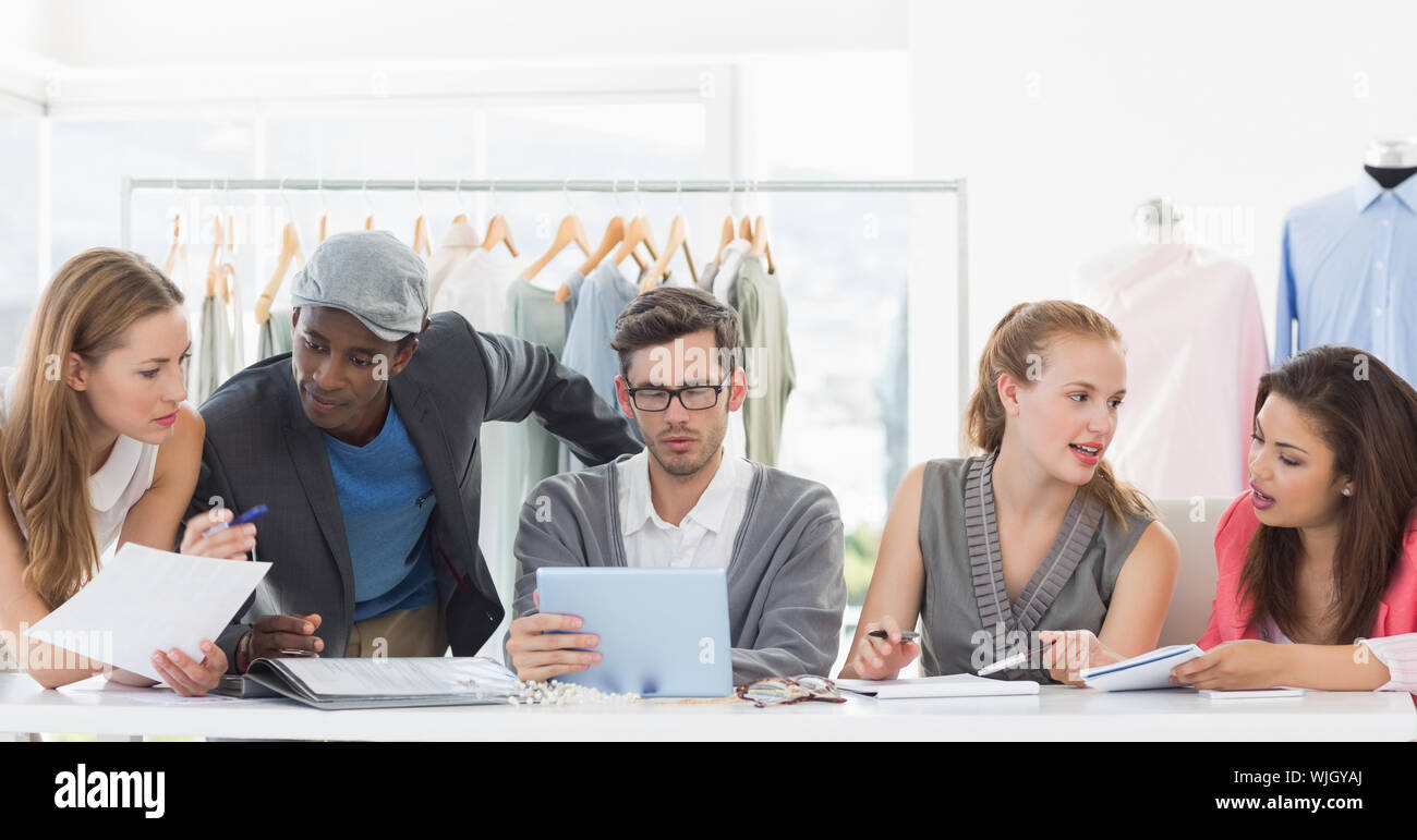 Group of fashion designers discussing designs in a studio Stock Photo ...