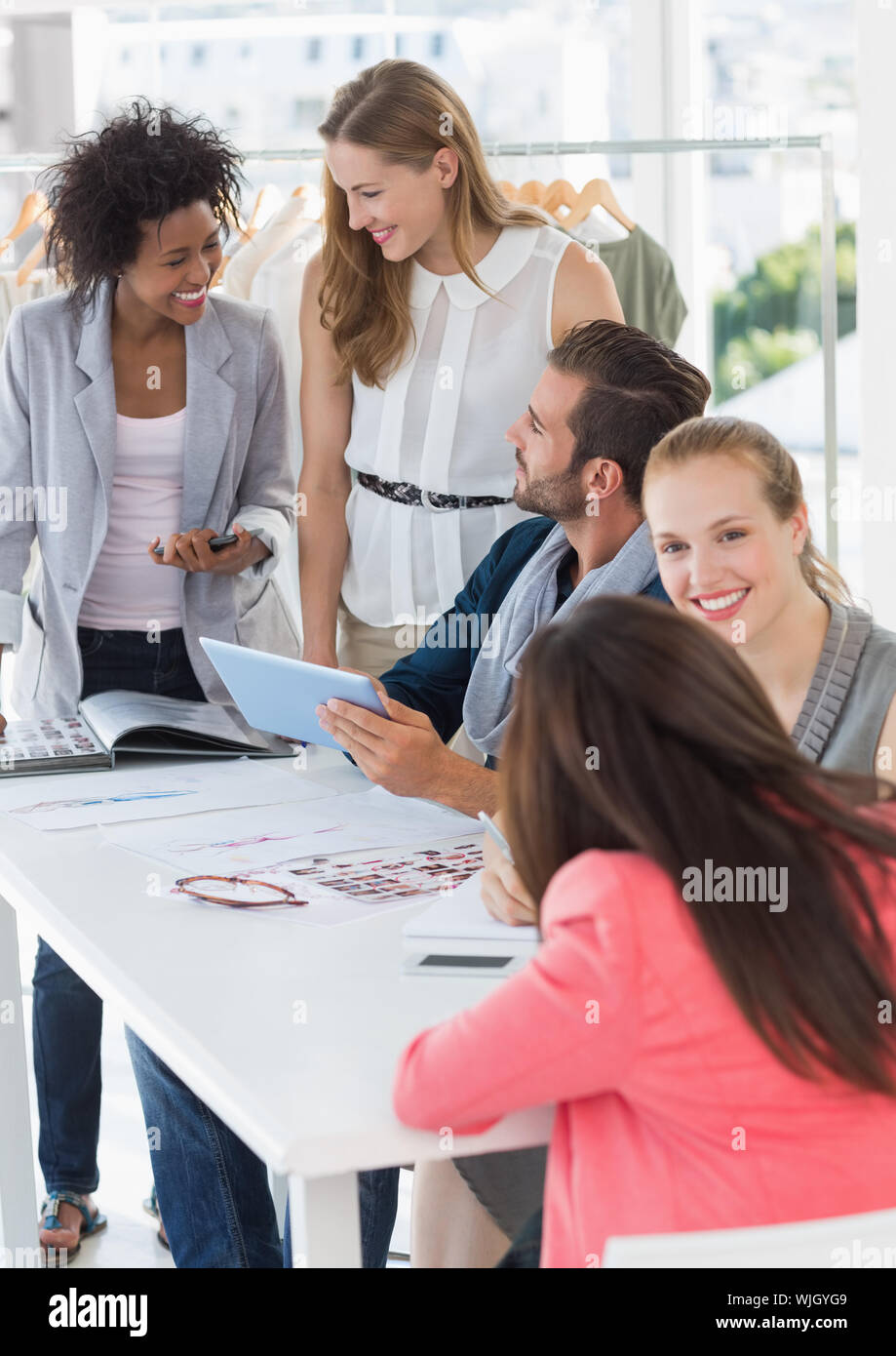 Group of fashion designers discussing designs in a studio Stock Photo ...