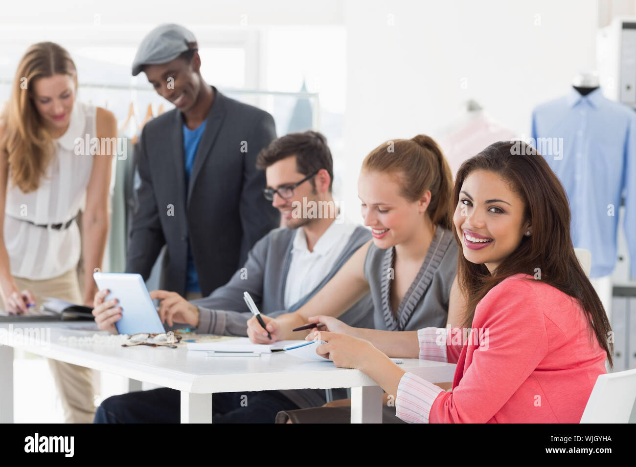 Group of fashion designers discussing designs in a studio Stock Photo ...