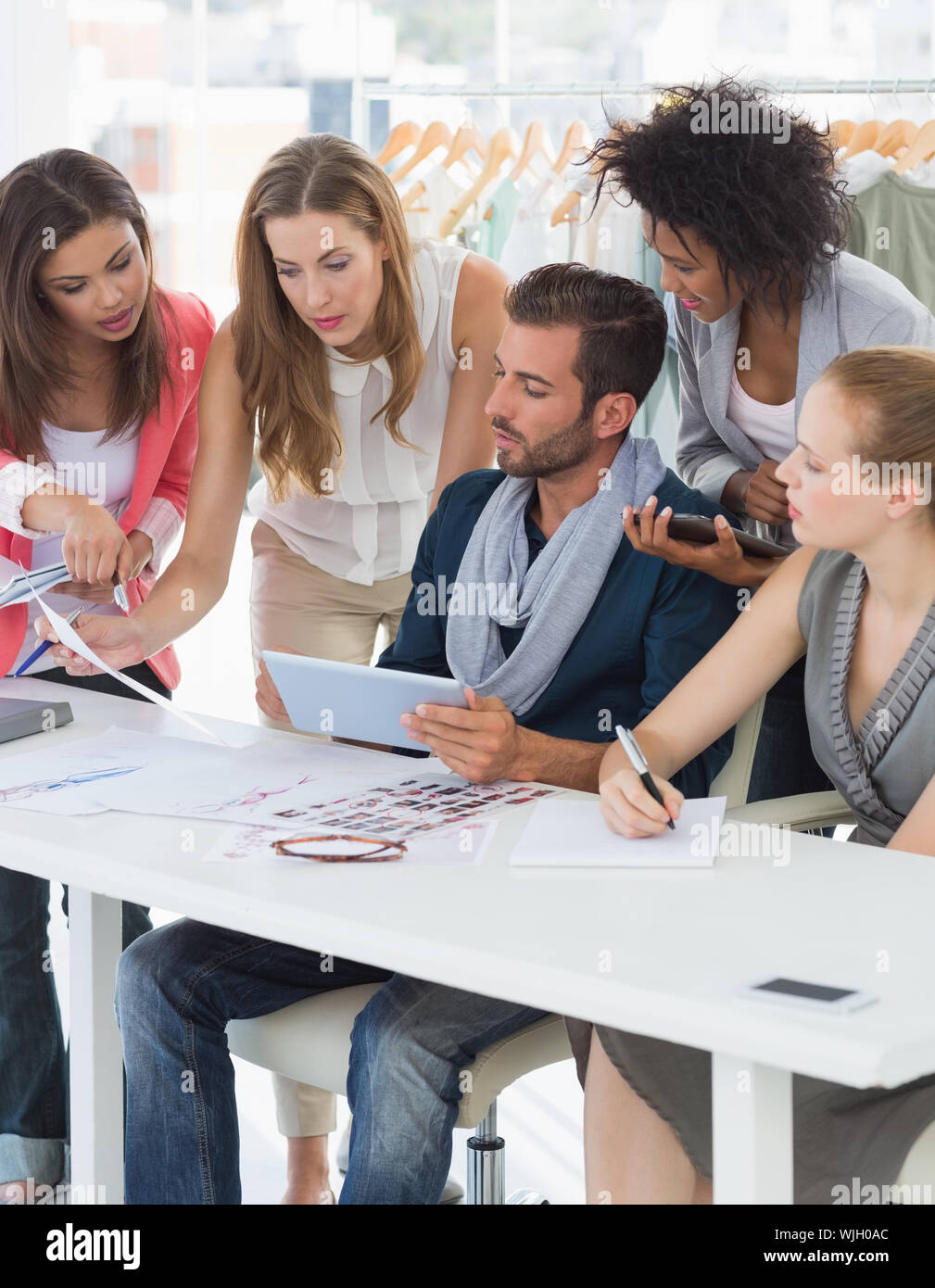 Group of fashion designers discussing designs in a studio Stock Photo ...