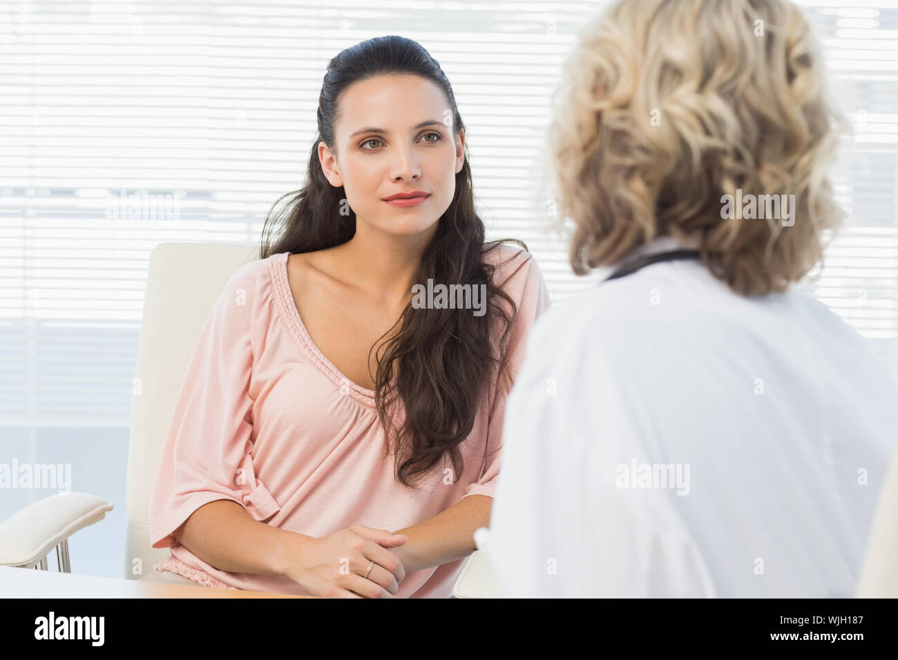 Female patient listening to doctor with concentration Stock Photo - Alamy
