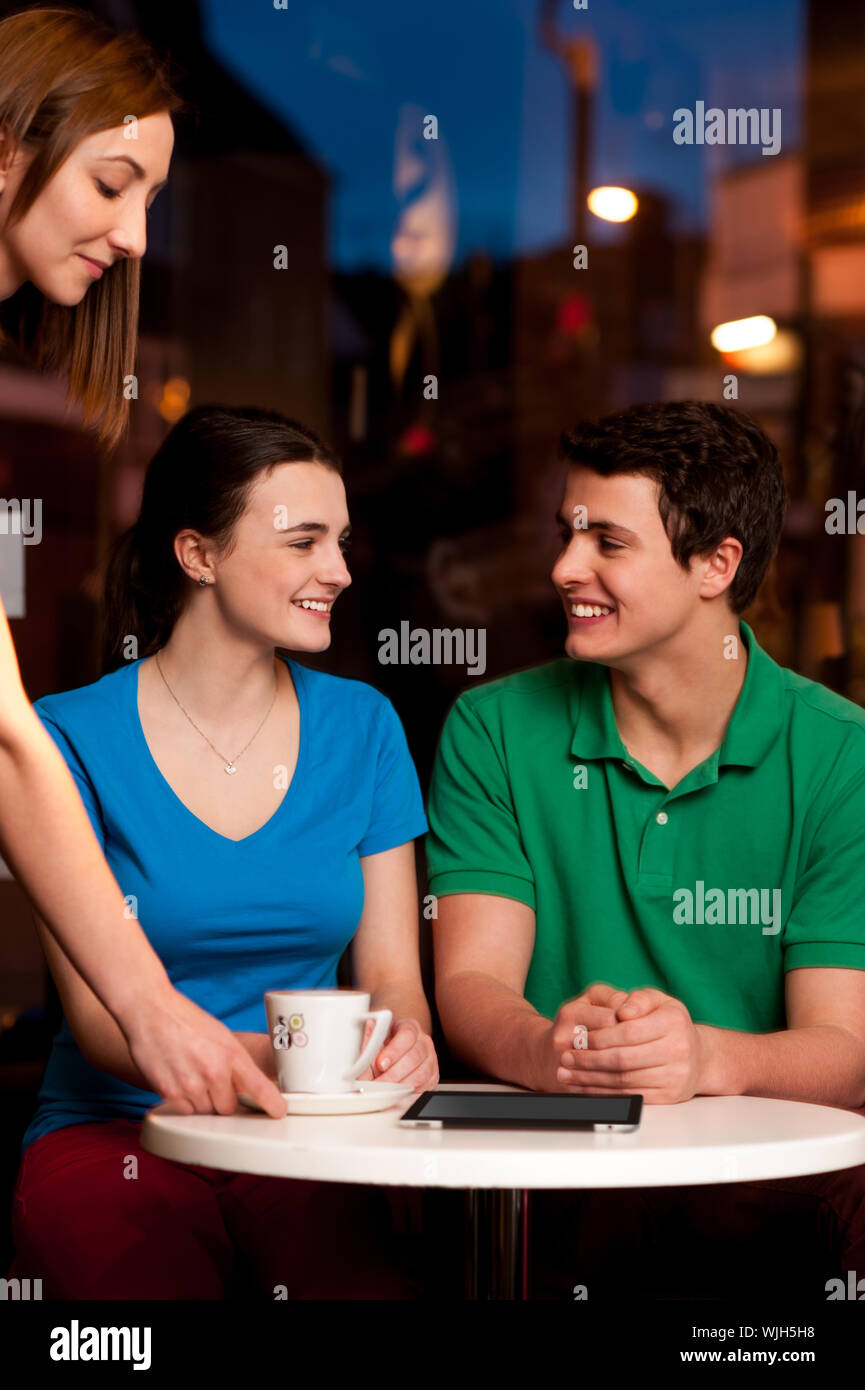 Brother and sister enjoying the coffee in cafe Stock Photo - Alamy