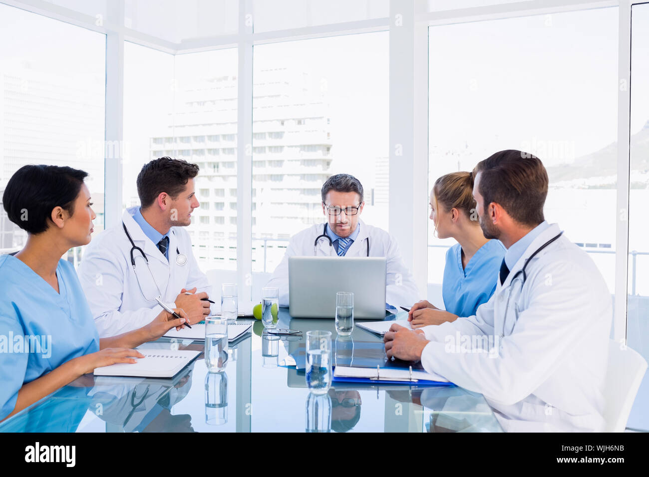 Concentrated medical team around desk in the office Stock Photo - Alamy