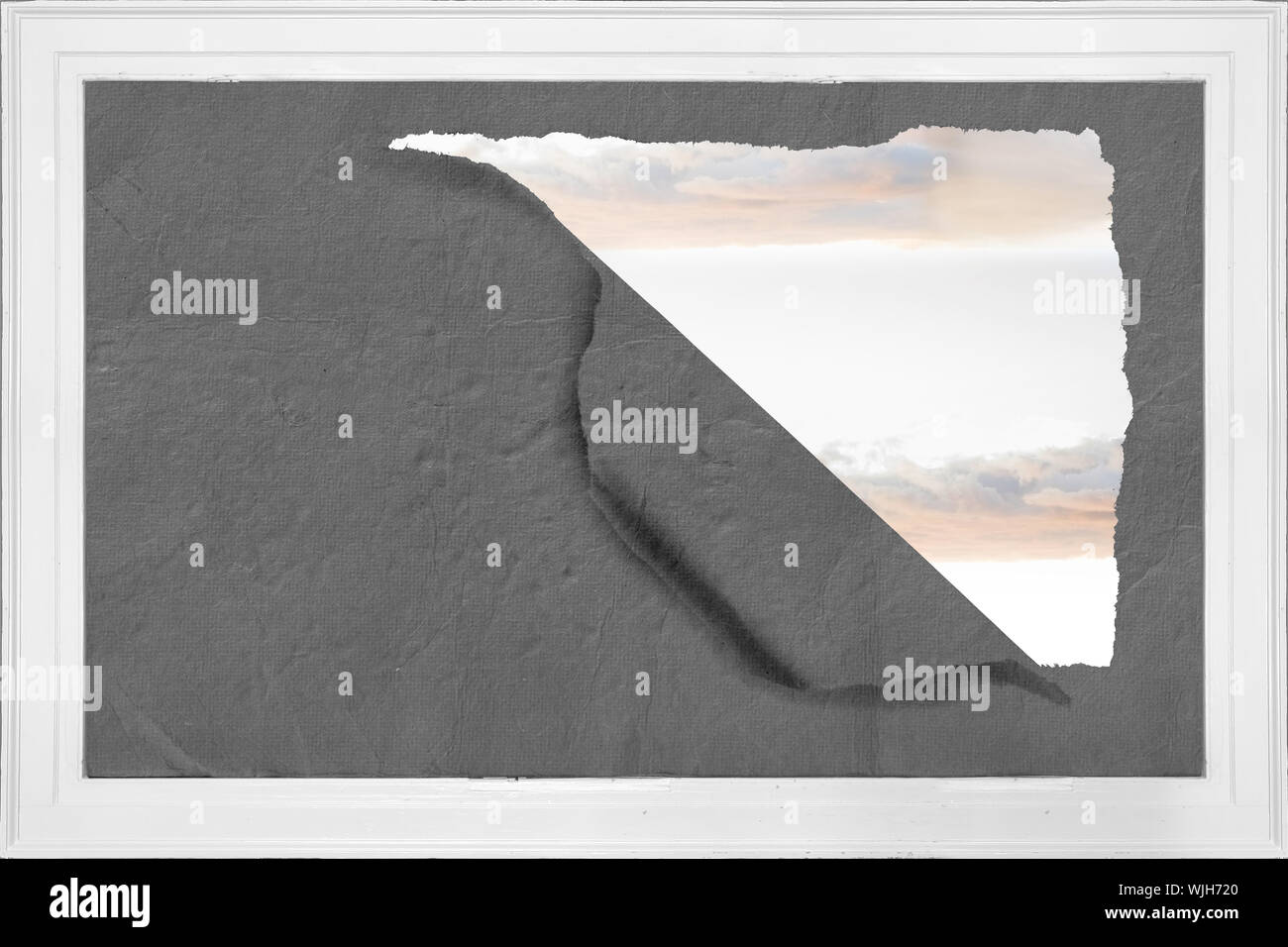 Rip on wall showing bright sky Stock Photo - Alamy