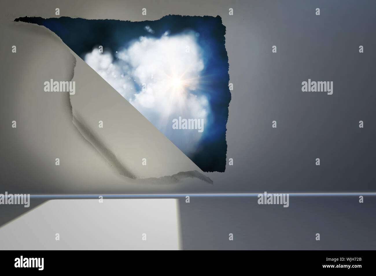Rip on wall showing cloud graphic Stock Photo - Alamy