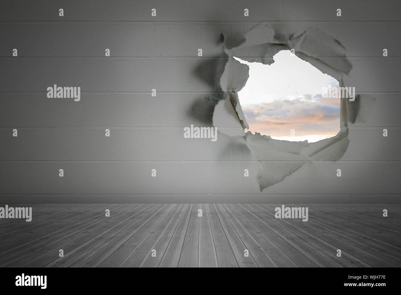 Rip on wall showing bright sky Stock Photo - Alamy