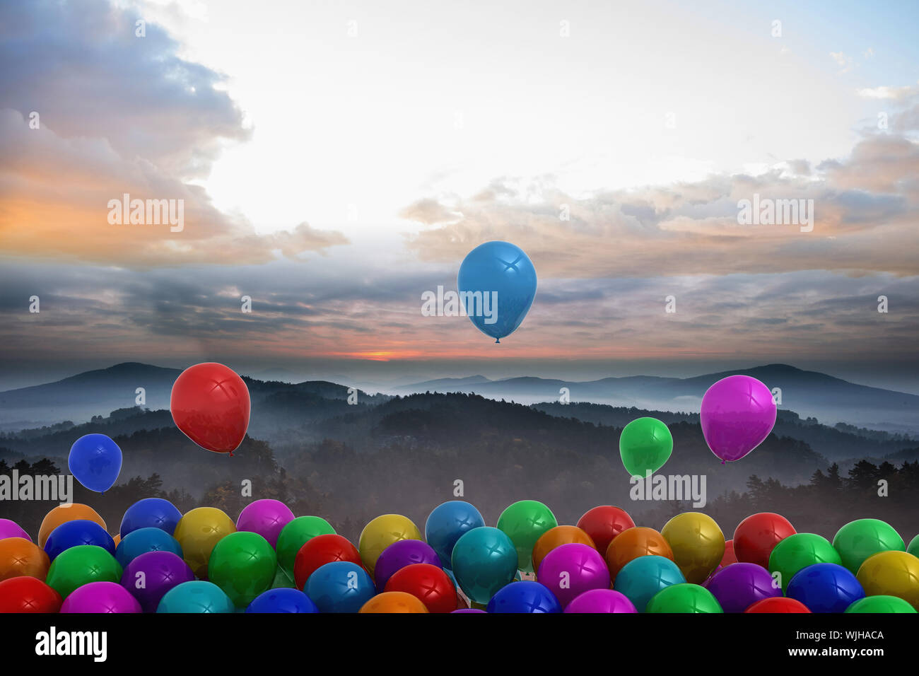Many colourful balloons above landscape Stock Photo - Alamy