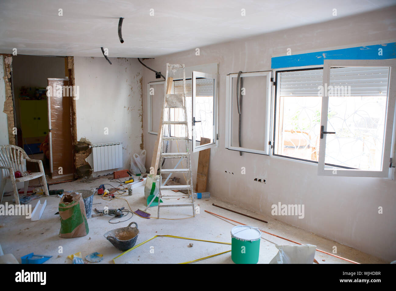 House indoor improvements in a messy room construction with plaste ...