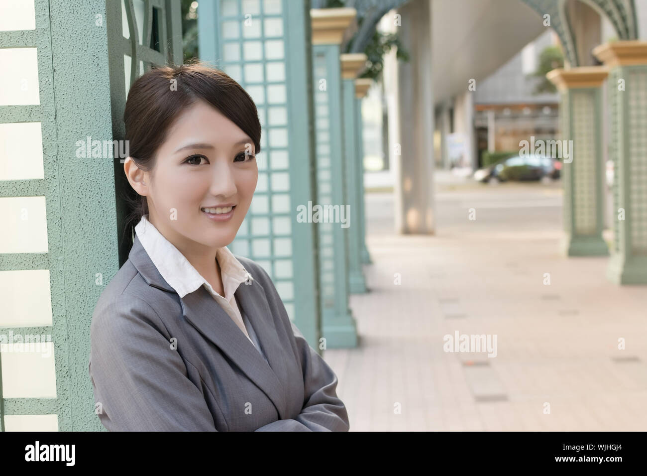 Friendly business woman of Asian with copyspace in modern city Stock ...