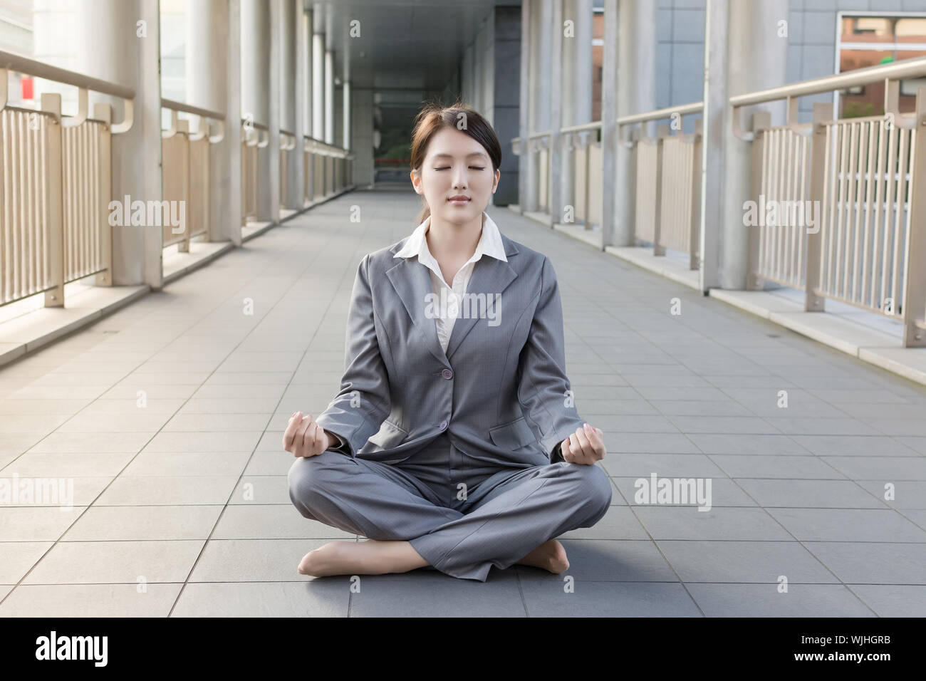 Tranquility or contemplative concept with business woman sit on ground ...
