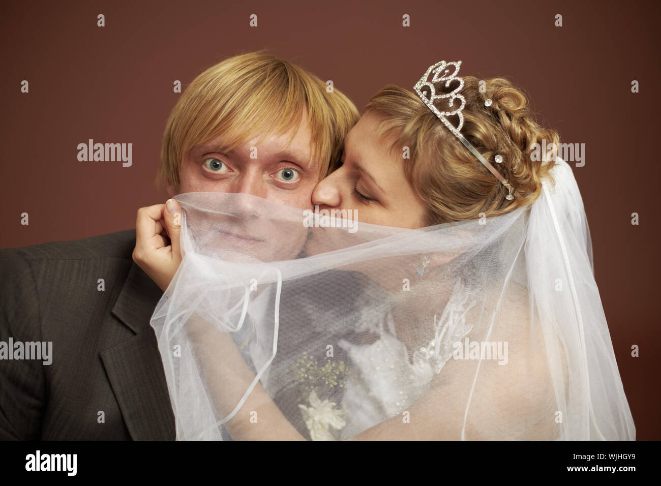 Funny bride and groom were closed veil Stock Photo - Alamy