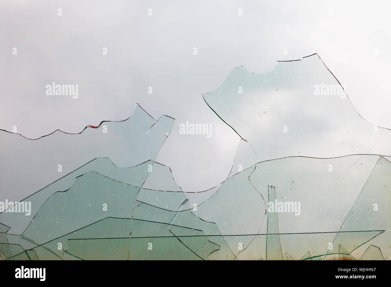 View from the window through the old broken glass Stock Photo - Alamy